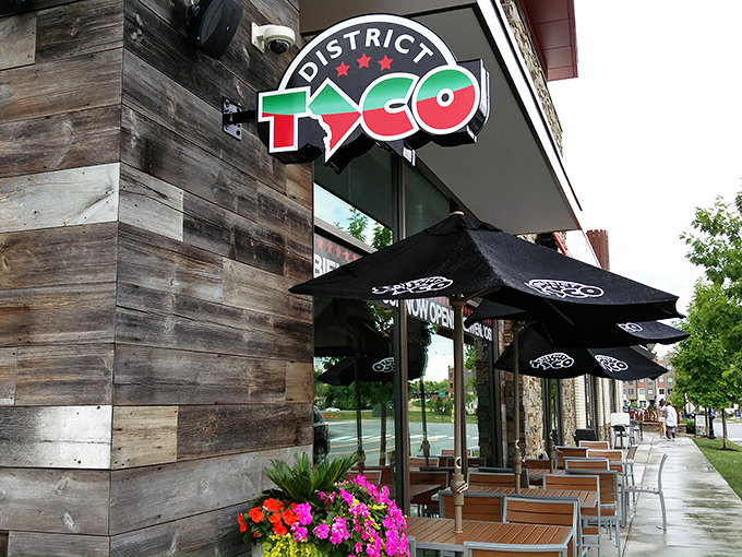 The rustic wooden exterior of District Taco welcomes hungry visitors with its vibrant sign and colorful flower boxes&mdash;a taco oasis in King of Prussia.