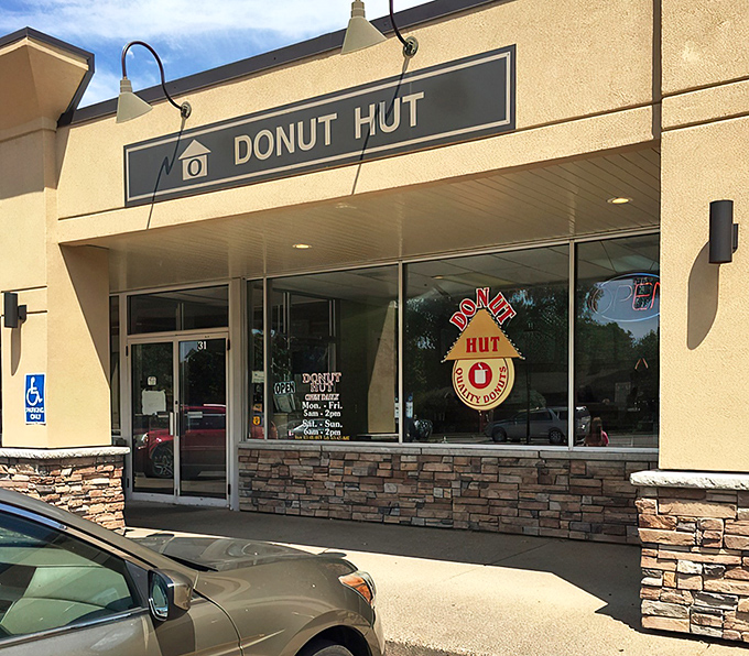 The humble storefront belies the sugary treasures within. Donut Hut's glowing "OPEN" sign serves as a beacon for pastry pilgrims across the Twin Cities.