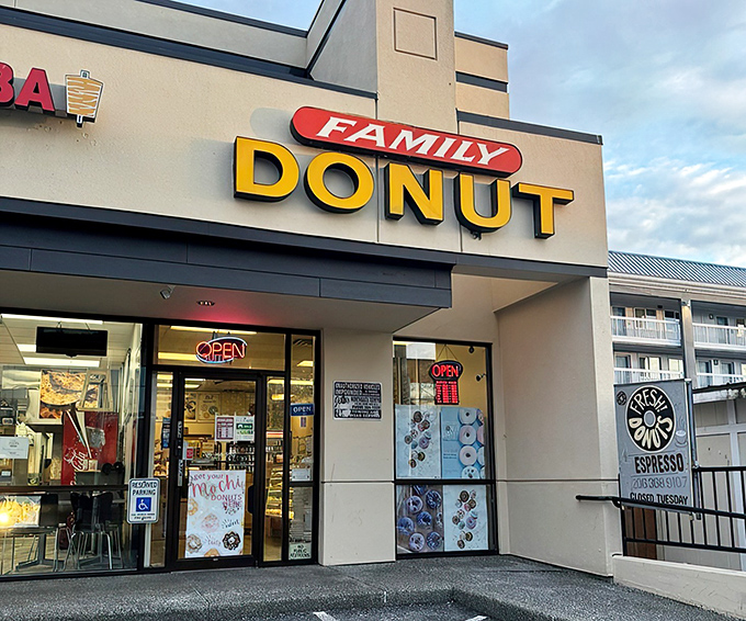 The yellow "DONUT" sign beckons like a lighthouse guiding sugar-seeking ships through morning fog. This unassuming storefront holds Seattle's sweetest treasures. 