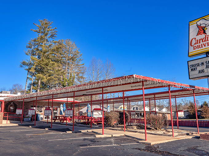 The iconic Cardinal Drive-In sign stands tall against the Carolina blue sky, beckoning hungry travelers with its retro charm and promise of comfort food paradise.