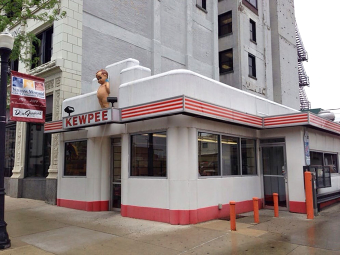 The iconic Kewpee exterior stands like a time capsule of Americana, complete with that watchful doll perched atop like a burger guardian angel.