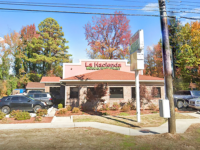 The unassuming salmon-colored exterior of La Hacienda stands like a culinary lighthouse amid autumn foliage, promising authentic Mexican treasures within.