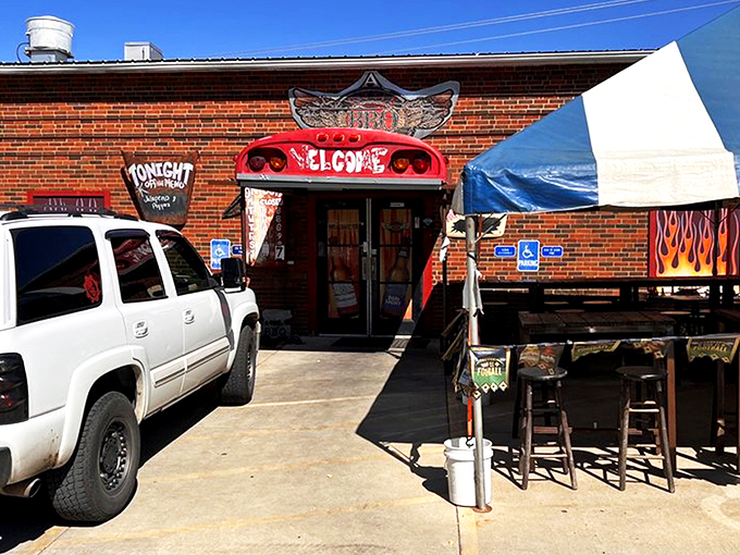 The entrance says it all: repurposed school bus meets flame-adorned brick wall. Barbecue paradise doesn't need fancy signage when the aroma does the talking.