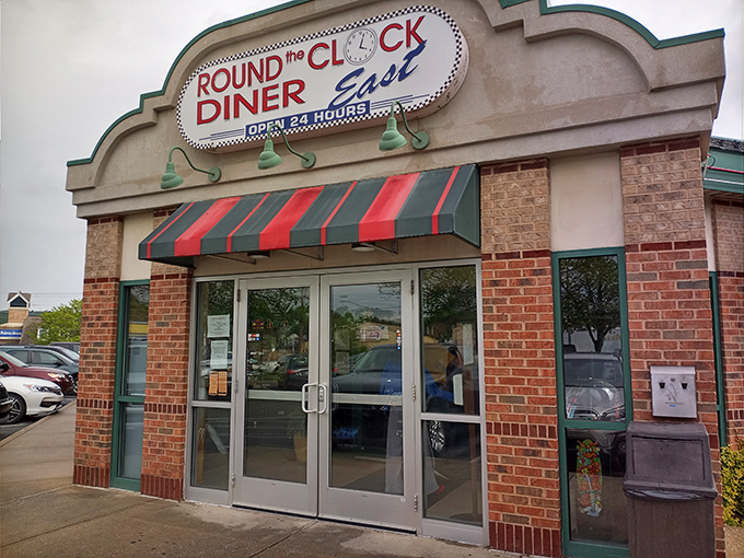 The classic brick exterior with its red and green awning stands like a beacon to hungry travelers. Diner paradise awaits 24/7! 
