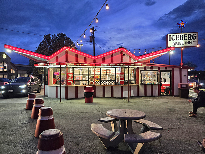 The iconic red and white striped exterior of Iceberg Drive Inn stands like a time capsule on 3900 South, promising nostalgic delights within.