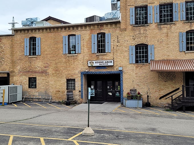 Stone Arch Brewpub's historic brick exterior with blue shutters stands as Appleton's answer to "where should we eat tonight?" Timeless charm meets modern craft brewing.