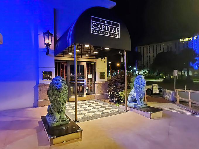 The iconic blue-canopied entrance guarded by regal lion statues promises an experience that's anything but ordinary. This is your gateway to carnivorous bliss.