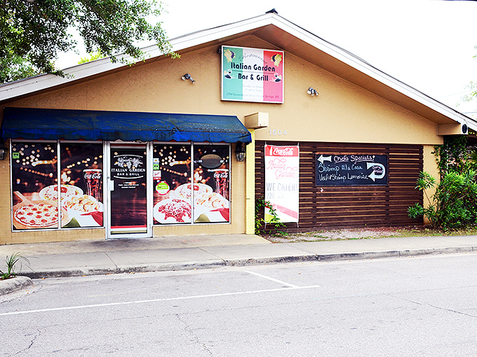 The welcoming facade of Italian Garden beckons hungry travelers with its cheerful signage and cozy entrance. A hidden gem waiting to be discovered. 