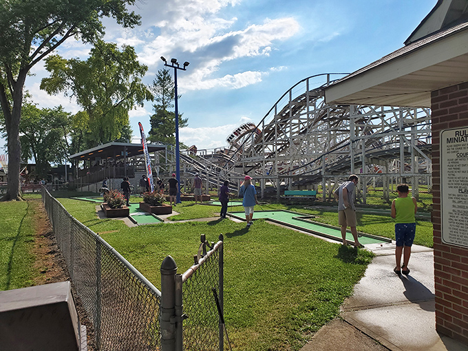 The classic Scrambler ride spins against a backdrop of wooden coaster tracks &ndash; a perfect snapshot of old-school amusement park magic that never goes out of style.