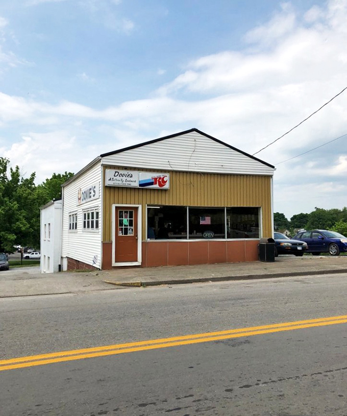 The unassuming white exterior of Dovie's stands like a culinary lighthouse in Tompkinsville, beckoning burger pilgrims from across Kentucky's rolling hills.