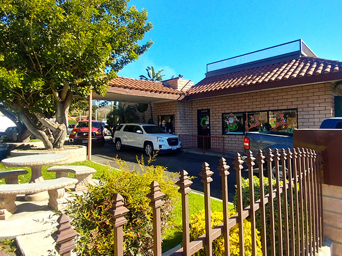 The red-tiled roof and brick facade of Old Time Drive In stands as a beacon of comfort food in Sun Valley, where California sunshine meets classic American dining.