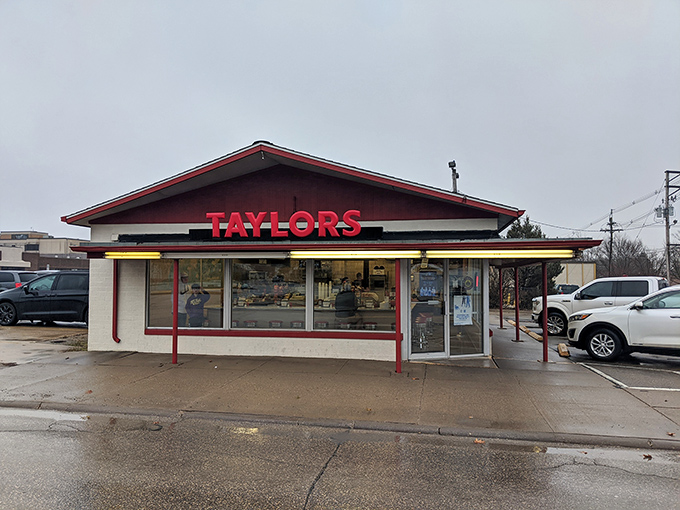The classic red and white exterior of Taylor's Maid-Rite stands as a beacon of culinary tradition in downtown Marshalltown, promising loose-meat perfection within. 