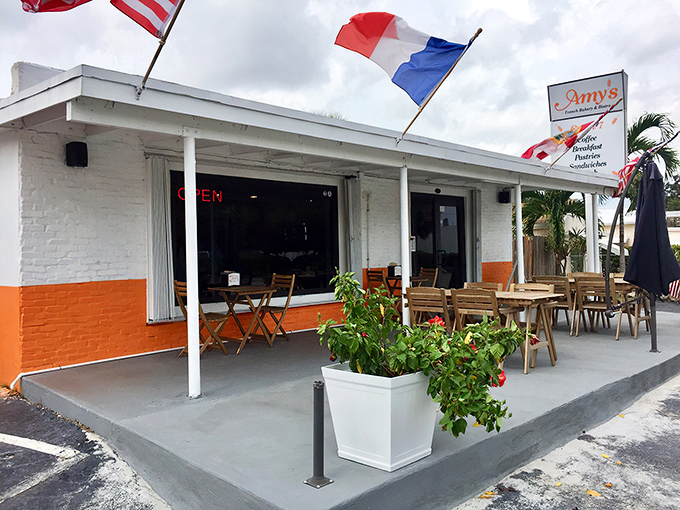 Amy's charming exterior welcomes you with a splash of European flair. Those red awnings and potted flowers aren't just decoration&mdash;they're a promise of the warmth waiting inside.
