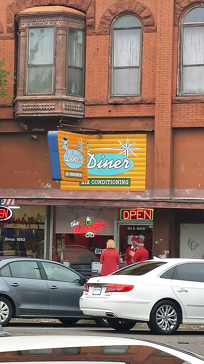 That vintage orange and teal sign isn't just advertising air conditioning&mdash;it's promising a time machine to when breakfast was an event worth getting dressed for.