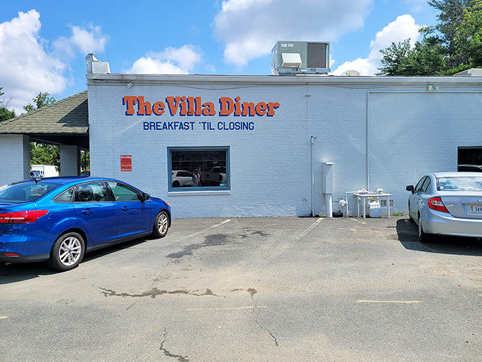 The unassuming white brick exterior with bright orange lettering promises what every breakfast lover dreams of: "BREAKFAST 'TIL CLOSING." No false advertising here.