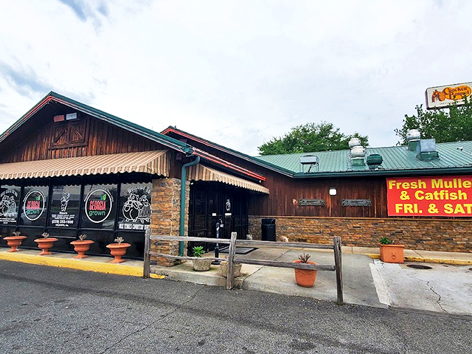 The rustic stone-and-wood exterior of Ole Times promises what every hungry traveler dreams of &ndash; authentic Southern comfort in buffet form.