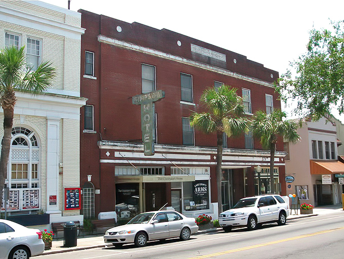Historic brick buildings line Mount Dora's main street, where palm trees and vintage architecture create that perfect "Old Florida meets small-town charm" vibe.