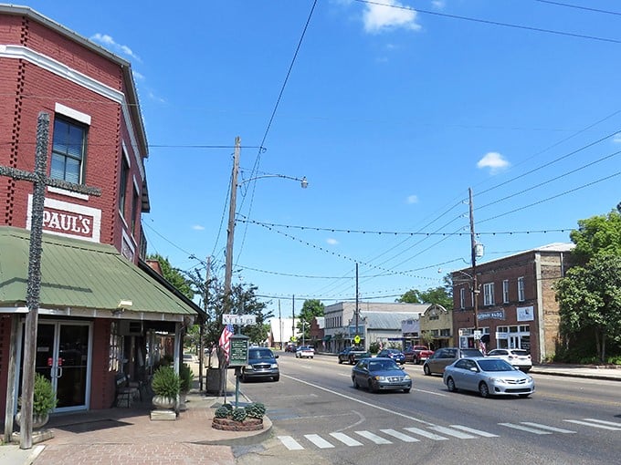Paul's Café anchors the corner of Ponchatoula's historic downtown, where string lights create an everyday celebration atmosphere along brick-paved streets.