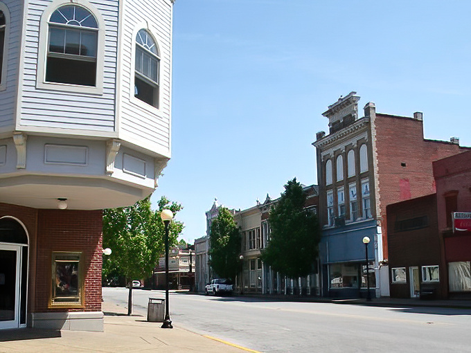 Historic charm meets small-town serenity on New Harmony's Main Street, where brick buildings whisper stories of utopian dreams and antique treasures await.