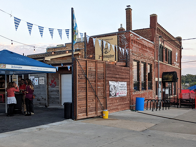 The brick exterior of Rathskeller Bier Haus stands proudly in Omaha, complete with Bavarian blue and white flags fluttering in the Nebraska breeze.