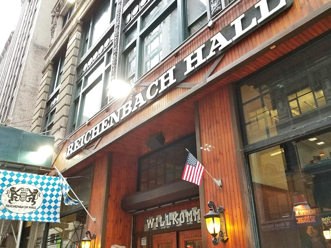 The wooden facade of Reichenbach Hall beckons with its "WILLKOMM" sign, like a warm German hug in the middle of Manhattan's concrete jungle.