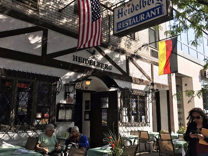The storybook facade of Heidelberg Restaurant beckons with its warm yellow glow, promising Bavarian magic in the heart of Manhattan's concrete jungle.