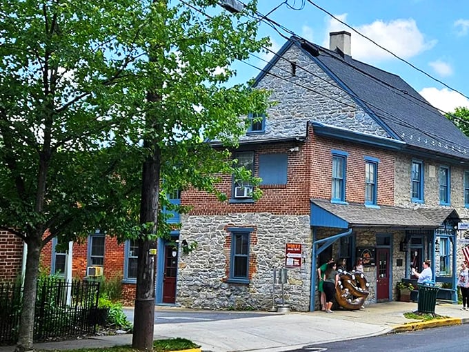 A stone and brick facade with bright blue trim and welcoming red doors &ndash; Julius Sturgis stands as a beacon of pretzel perfection in charming Lititz.