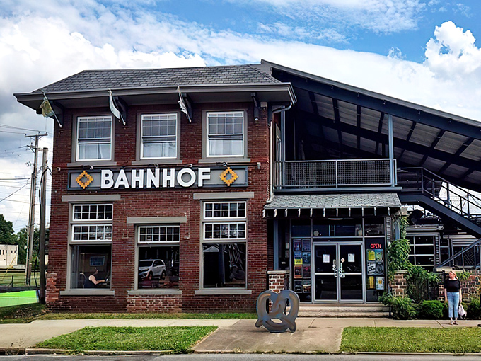The brick facade of Bahnhof WVrsthaus & Biergarten stands proudly in Huntington, with that giant pretzel sculpture practically winking at hungry passersby.