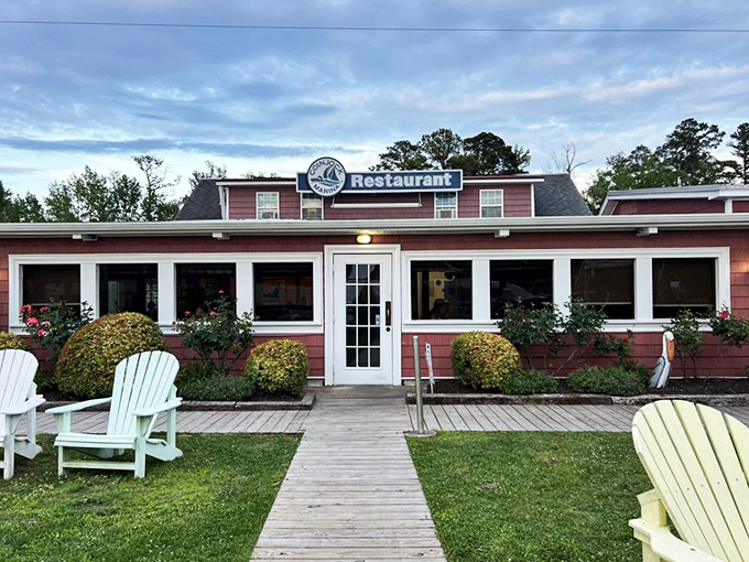 The unassuming pink exterior of Coinjock Marina Restaurant&mdash;proof that culinary treasures often hide in plain sight along North Carolina's waterways.