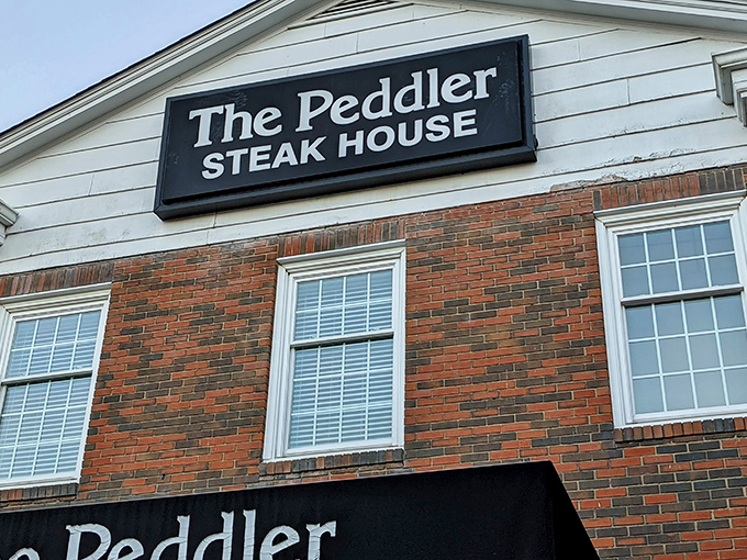 The brick fa&ccedil;ade of The Peddler stands like a carnivore's lighthouse, beckoning hungry travelers with its classic steakhouse promise. Some buildings just look delicious.