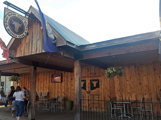 The rustic wooden exterior of The Hoof & Horn beckons like a frontier outpost for hungry travelers. Those swinging doors promise carnivorous delights within.
