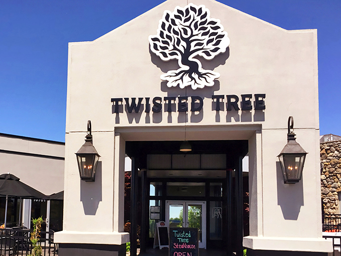 The welcoming facade of Twisted Tree Steakhouse stands proudly against the blue Missouri sky, lantern lights ready to guide hungry pilgrims to beef paradise.