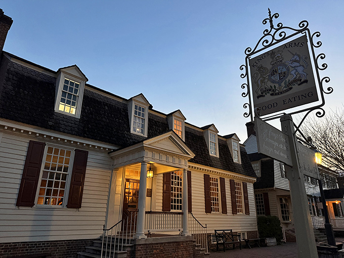 Colonial charm meets twilight magic at King's Arms Tavern, where the glowing windows promise warmth and "GOOD EATING" after a day of historical wanderings.