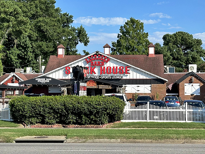 The iconic red lettering of Aberdeen Barn beckons like a lighthouse for hungry souls. This barn-shaped beacon has been guiding steak lovers to beefy bliss for generations.