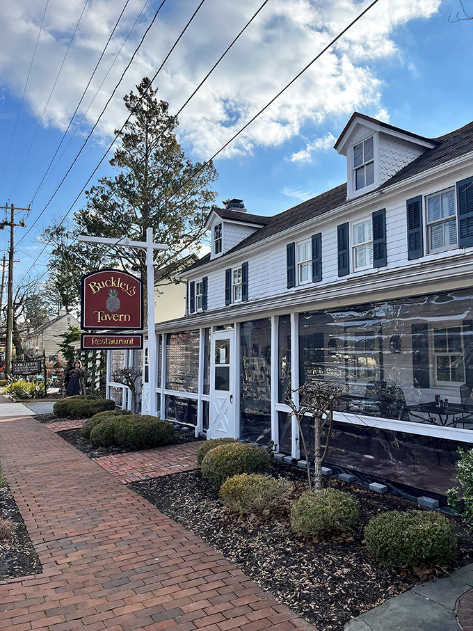 A storybook come to life! Buckley's Tavern's charming exterior beckons with its white clapboard siding, inviting porch, and lush gardens. It's the culinary equivalent of a warm hug.