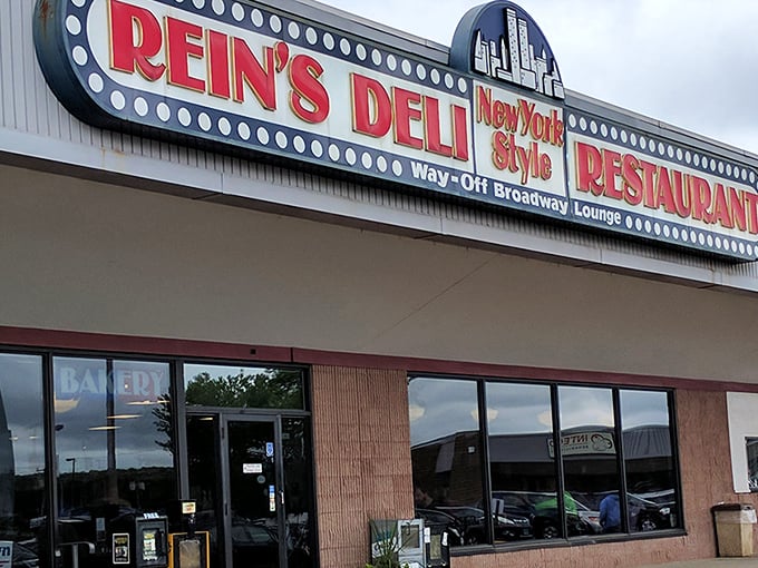 The iconic Rein's Deli sign glows like a Broadway marquee in Connecticut, promising New York flavors without the traffic or attitude.
