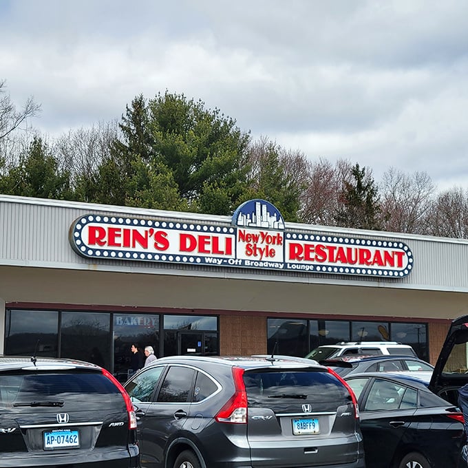 The iconic Rein's Deli sign glows like a Broadway marquee in Connecticut, promising New York flavors without the traffic or attitude.