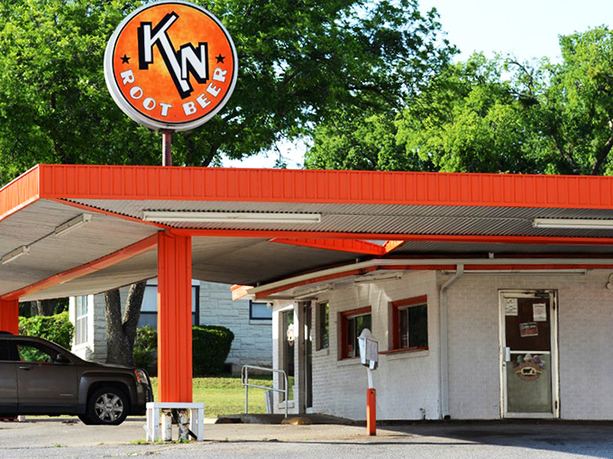 The unassuming exterior of K N Root Beer Drive In proves once again that Texas's greatest culinary treasures often hide in plain sight.