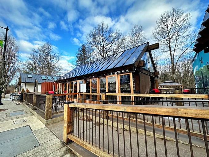 The timber-framed outdoor seating area beckons like an old friend, promising cold brews and mountain views that'll make your city stress evaporate instantly.