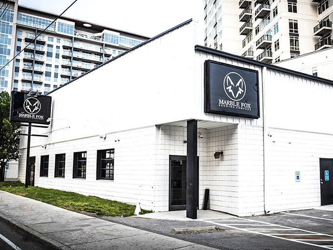 The unassuming white exterior of Marble Fox Brewing Company stands like a blank canvas, hiding the flavor explosion waiting inside. Nashville's best-kept liquid secret.