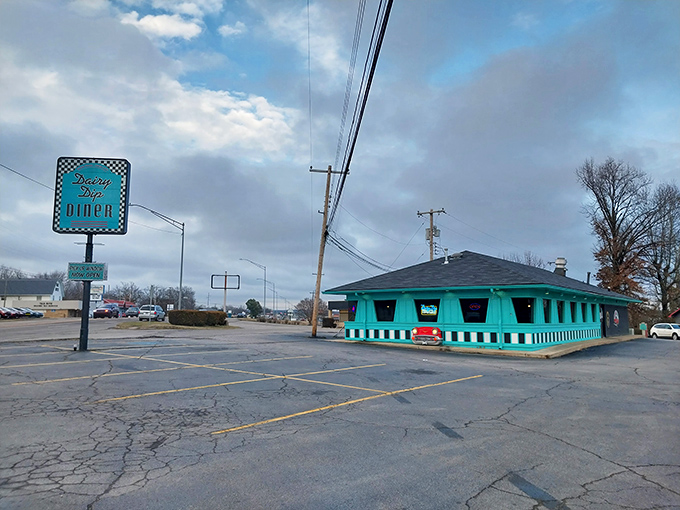 The turquoise time capsule beckons from the roadside, complete with classic car grille built right into the fa&ccedil;ade. Mid-century perfection awaits inside.