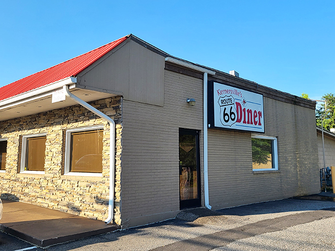 The iconic shield-shaped sign beckons like a time machine disguised as a roadside beacon. Classic Americana awaits inside!