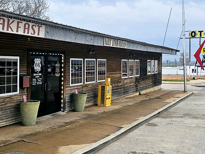 The weathered wooden exterior of Route 66 Cafe stands like a time capsule on Clinton's main drag, beckoning hungry travelers with promises of home cooking and nostalgia.