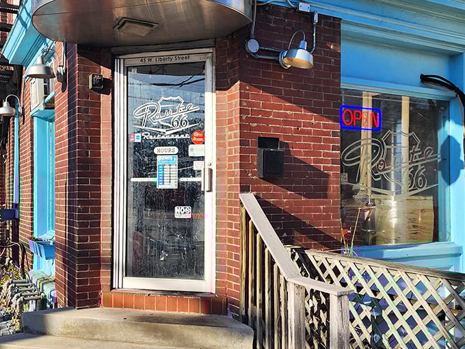 The unassuming brick entrance with its vibrant blue trim promises more than meets the eye&mdash;a perfect roadside discovery hiding in plain sight on Liberty Street.