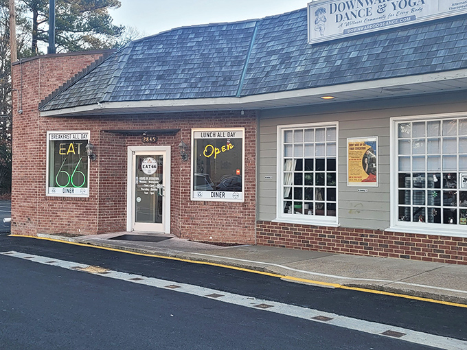 The brick facade of Eat 66 beckons like a time portal to simpler days, when "breakfast all day" was the sweetest promise a neon sign could make.
