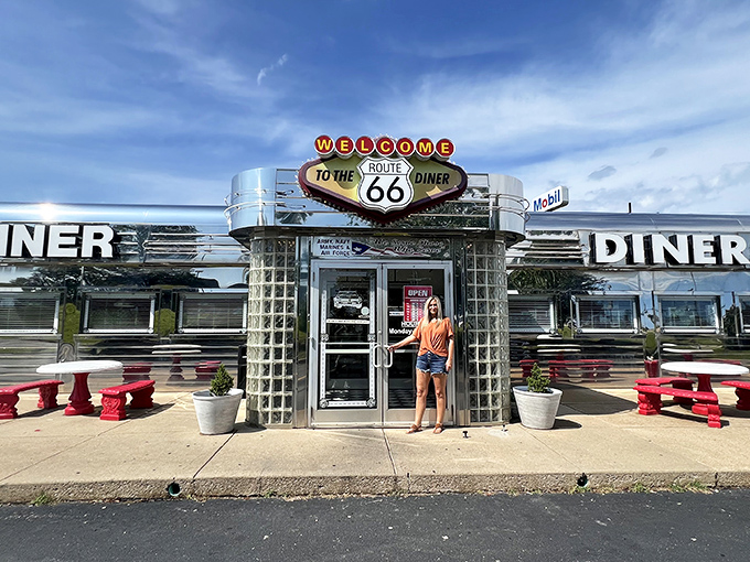 That iconic sign beckons like a chrome-clad siren song from the roadside, promising a journey back to when highways meant adventure, not just commutes.