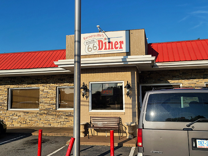 The iconic shield-shaped sign beckons like a time machine disguised as a roadside beacon. Classic Americana awaits inside!