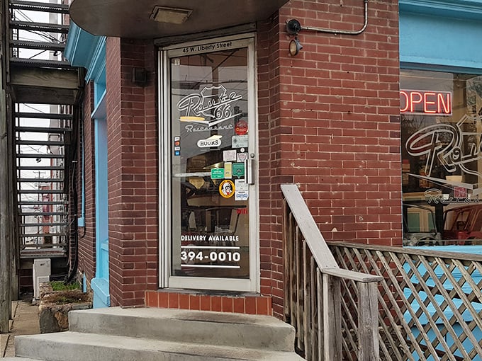 The unassuming brick entrance with its vibrant blue trim promises more than meets the eye&mdash;a perfect roadside discovery hiding in plain sight on Liberty Street.