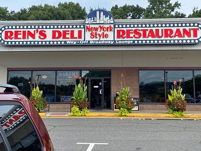 The iconic yellow exterior of Rein's Deli stands like a beacon of hope for hungry travelers on I-84, promising New York deli salvation in Connecticut.
