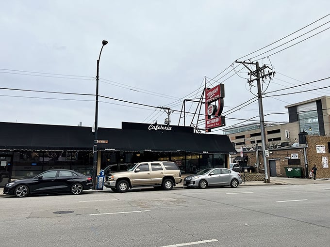 Manny's iconic red sign stands like a culinary lighthouse against Chicago's skyline, promising delicious refuge from the busy world outside.